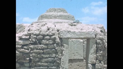1950s: Small stone hut. Man laying brick... | Stock Video | Pond5