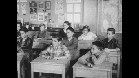 1950s: Students sit in classroom. Boy a... | Stock Video | Pond5
