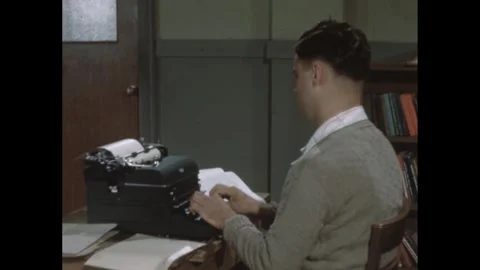 1950s: Teen boy typing on manual typewri... | Stock Video | Pond5