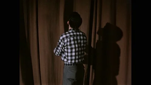 1950s: Theater, man stands on stage, tur... | Stock Video | Pond5