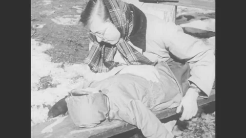 1950s: woman pins down and talks to boy ... | Stock Video | Pond5