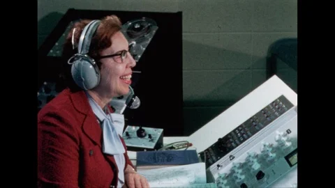 1950s: Woman sits at control panel, wear... | Stock Video | Pond5