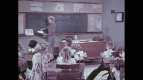 1950s:Teacher walks to chalkboard in cla... | Stock Video | Pond5