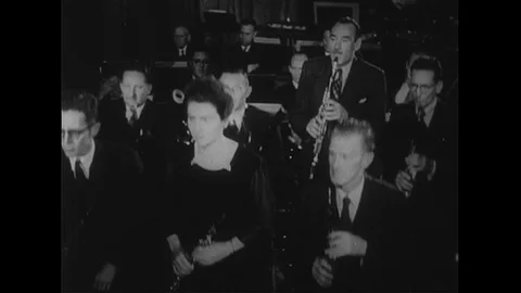 1951 : Members of an orchestra stand up ... | Stock Video | Pond5