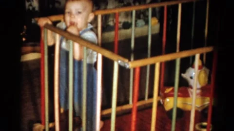 1959: a baby in overall peering over the... | Stock Video | Pond5