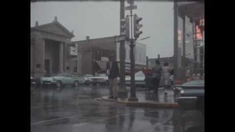 1960s: 2 women in rain gear run across w... | Stock Video | Pond5