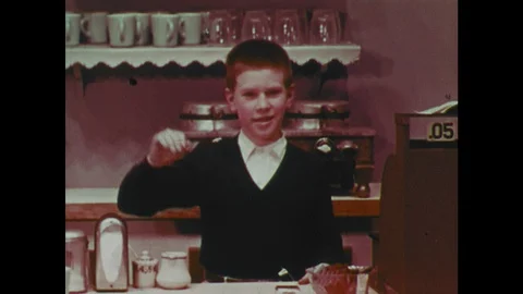 1960s: Boy stands behind counter, waves.... | Stock Video | Pond5
