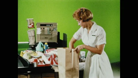 1960s: cashier bagging groceries, many c... | Stock Video | Pond5