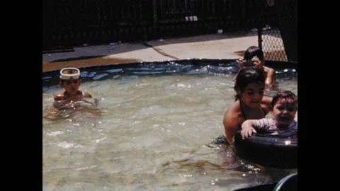 1960s: Children swim, play in pool in ya... | Stock Video | Pond5
