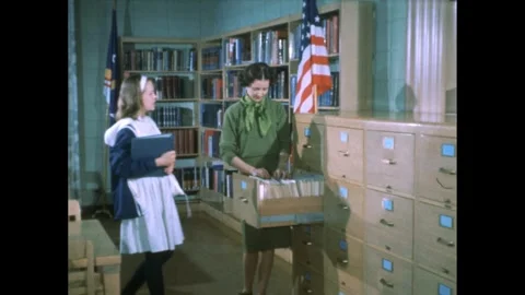 1960s: Clapperboard. School librarian lo... | Stock Video | Pond5