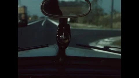 1960s: Compass hangs from rear view mirr... | Stock Video | Pond5