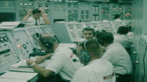 1960s: Control room. Men sit. Man stan... | Stock Video | Pond5