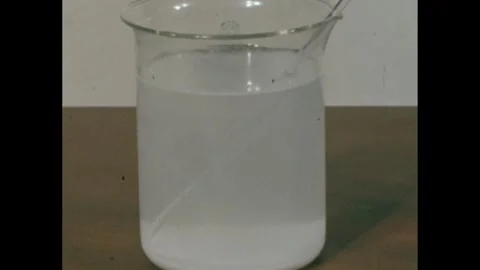 1960s: A glass beaker of cloudy liquid w... | Stock Video | Pond5