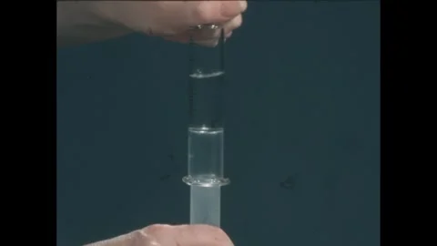 1960s: hands push down on inverted glass... | Stock Video | Pond5