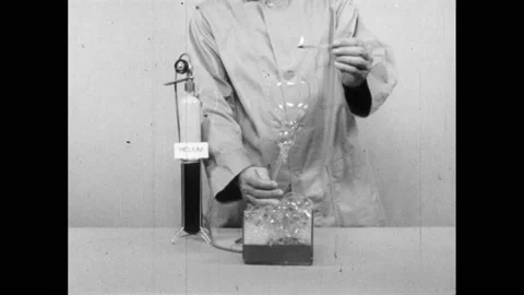 1960s: Lab, man uses helium tank to blow... | Stock Video | Pond5