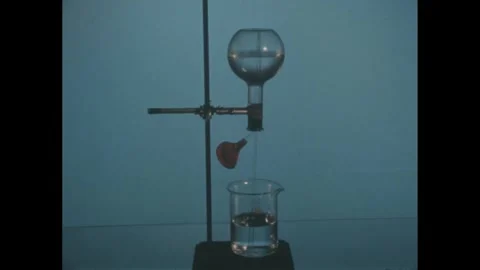 1960s: Liquid siphons from beaker into b... | Stock Video | Pond5