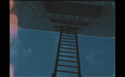 1960s: Low angle shots, man climbing lad... | Stock Video | Pond5
