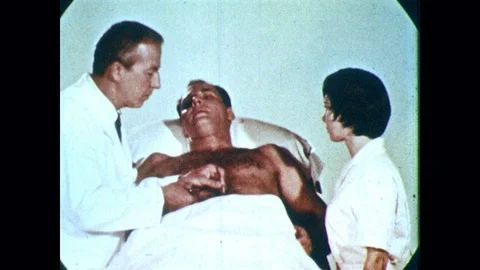 1960s: Male patient writhes in pain as d... | Stock Video | Pond5