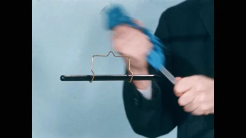 1960s: Man blowing on hanging probe. Han... | Stock Video | Pond5