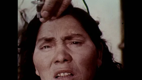 1960s: Man checks woman's eyes. Woman lo... | Stock Video | Pond5