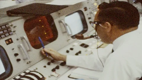 1960s: Man at control panel,looks at gra... | Stock Video | Pond5