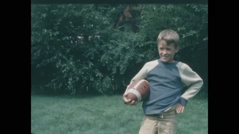 1960s: Man holds film slate. Boy runs wi... | Stock Video | Pond5