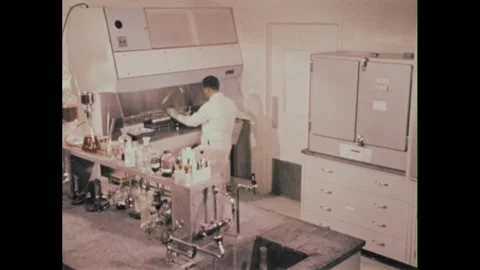 1960s: Man in lab takes vials of liquid ... | Stock Video | Pond5