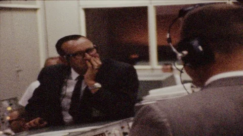 1960s: Man leaning on control panel, man... | Stock Video | Pond5
