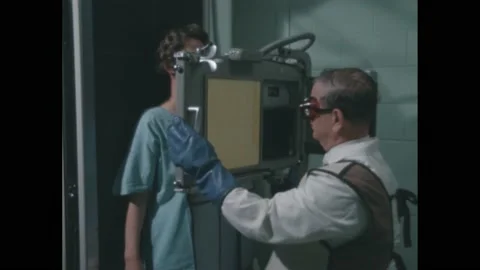1960s: Man positions x-ray device in fro... | Stock Video | Pond5