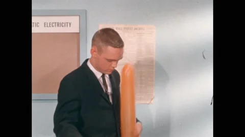 1960s: Man talking. Man rubbing balloon ... | Stock Video | Pond5