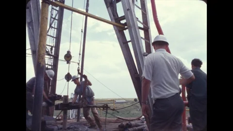 1960s: Men moving equipment on oil rig, ... | Stock Video | Pond5