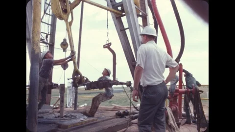 1960s: Men moving equipment on oil rig, ... | Stock Video | Pond5