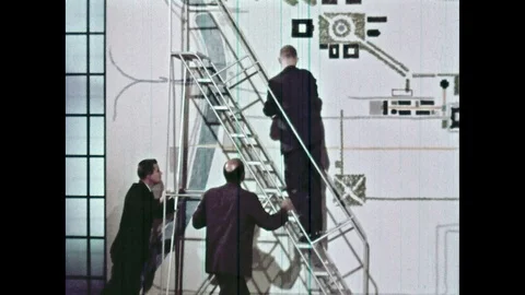 1960s: Men push man on ladder by large m... | Stock Video | Pond5