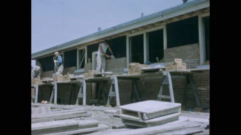 1960s: Men stand on scaffolding to lay b... | Stock Video | Pond5