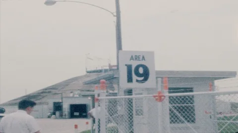1960s: Men walk past. Sign reads "AREA ... | Stock Video | Pond5