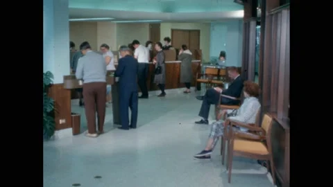 1960s: People in bank lobby. Customer ha... | Stock Video | Pond5