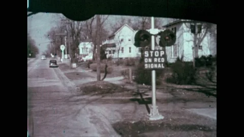 1960s: Railroad crossing signal. Boy loo... | Stock Video | Pond5