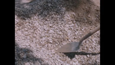 1960s: Shovel digging rocks. | Stock Video | Pond5