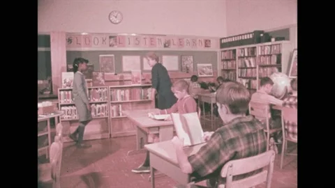 1960s: Students sit at desks in library,... | Stock Video | Pond5