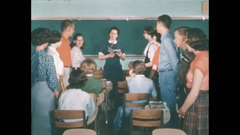 1960s: Teacher stands reading from book ... | Stock Video | Pond5