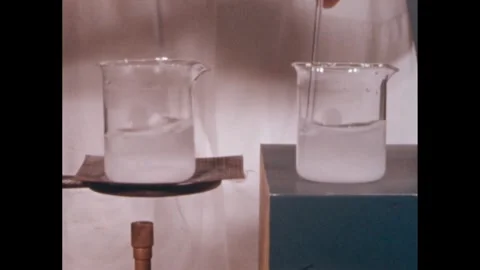 1960s: Two beakers of water: one on Buns... | Stock Video | Pond5