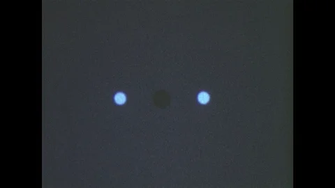 1960s: Two blue dots and a black dot. Di... | Stock Video | Pond5