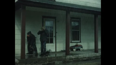 1960s: Two boys run under house front aw... | Stock Video | Pond5