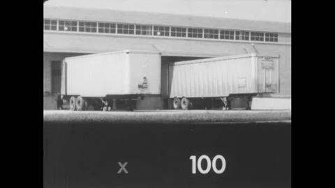 1960s: Two semitrucks sit at a loading d... | Stock Video | Pond5