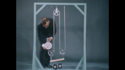1960s: Wooden frame. Man holds pulley a... | Stock Video | Pond5