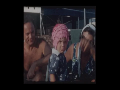 1962 Woman puts Pink bathing cap on emba... | Stock Video | Pond5