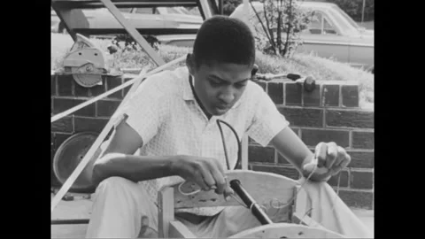 1963 - A teenager struggles with buildin... | Stock Video | Pond5