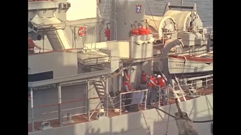 1965 - Men aboard the USS Firm heave on ... | Stock Video | Pond5