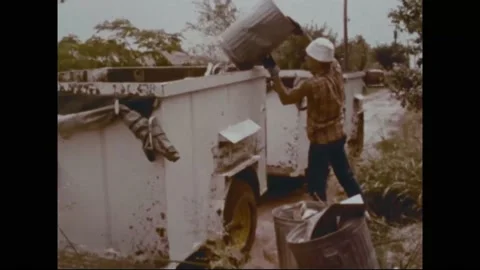 1970 - A truck hauls trash containers th... | Stock Video | Pond5
