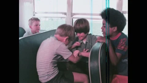 1970s: Children sit on a school bus. Boy... | Stock Video | Pond5